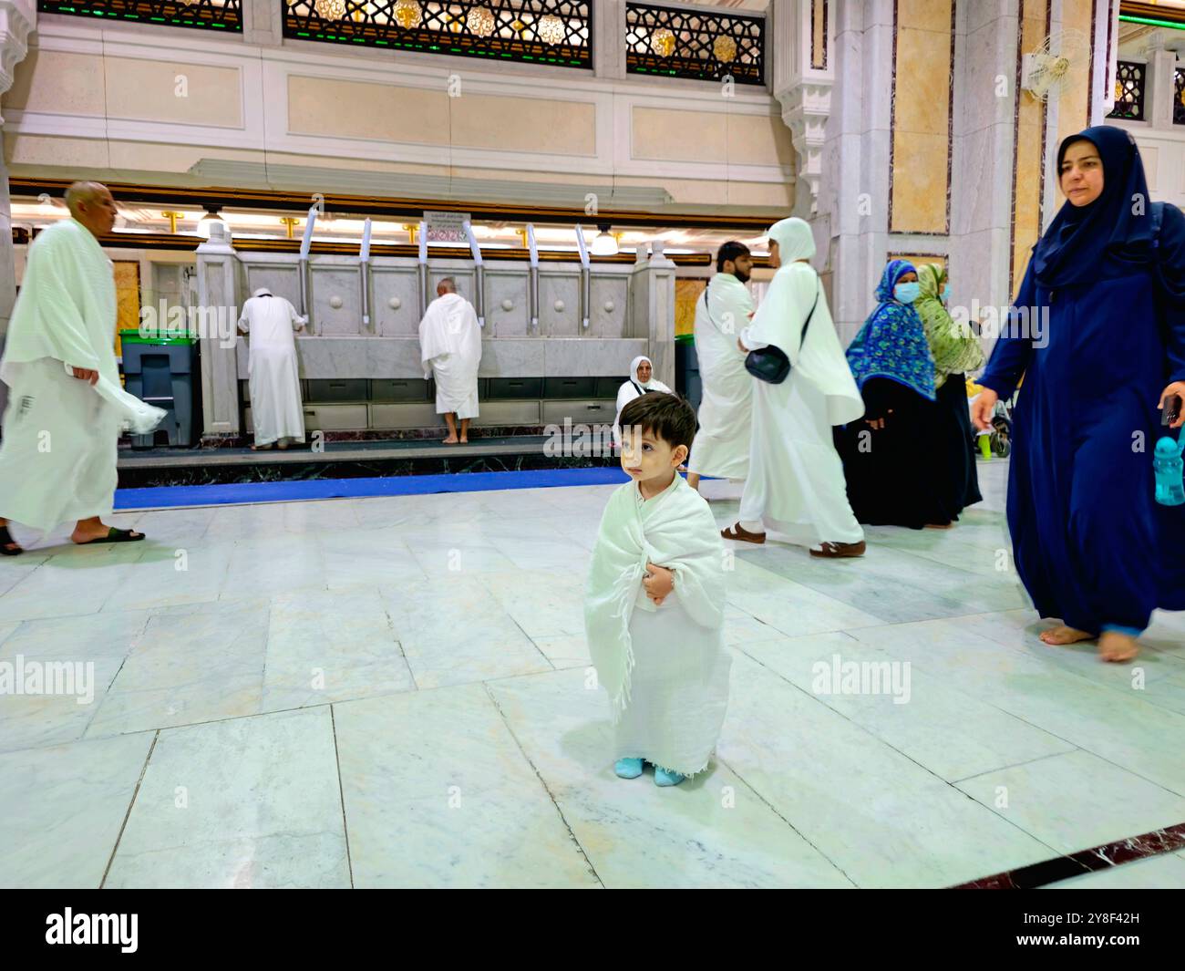 Mecca, Saudi Arabia, June 8 2024: A young pilgrim child with the ...