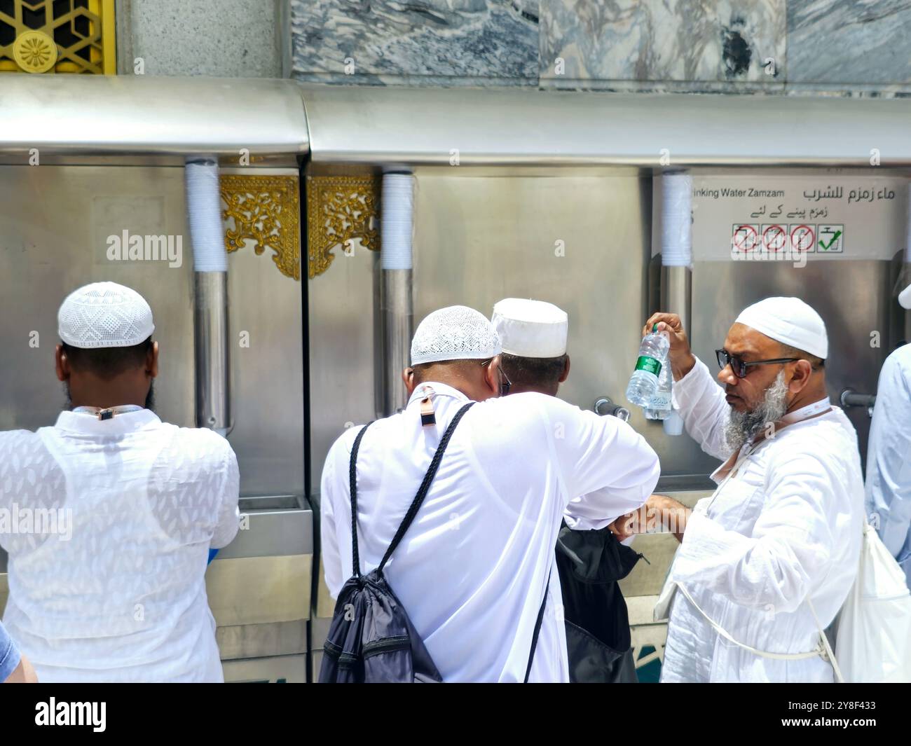 Mecca, Saudi Arabia, June 9 2024: pilgrims drinking from Zamzam well ...