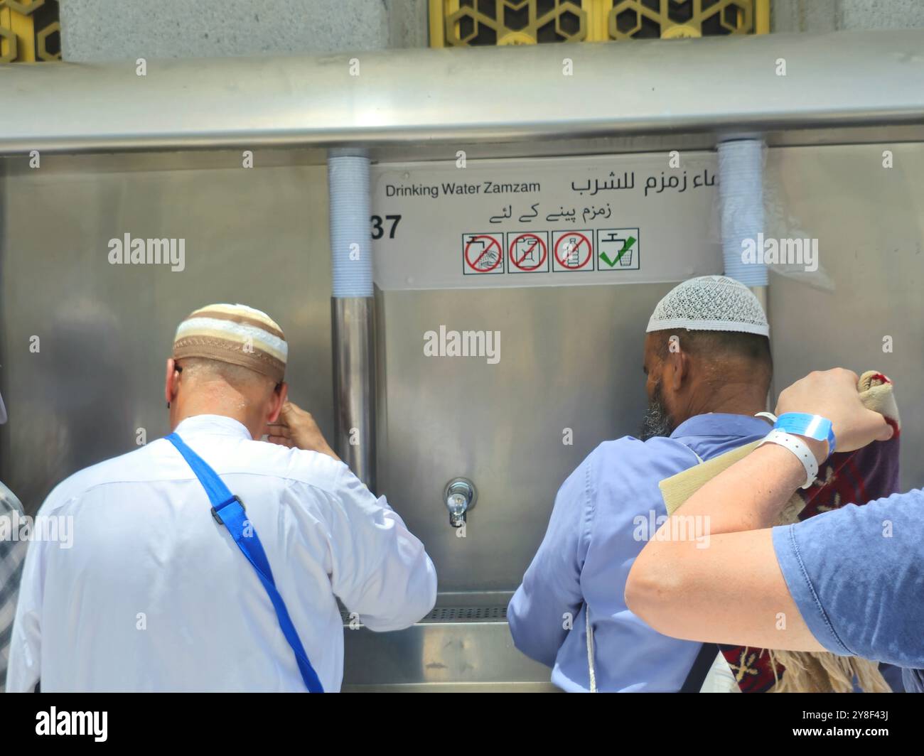Mecca, Saudi Arabia, June 9 2024: pilgrims drinking from Zamzam well ...