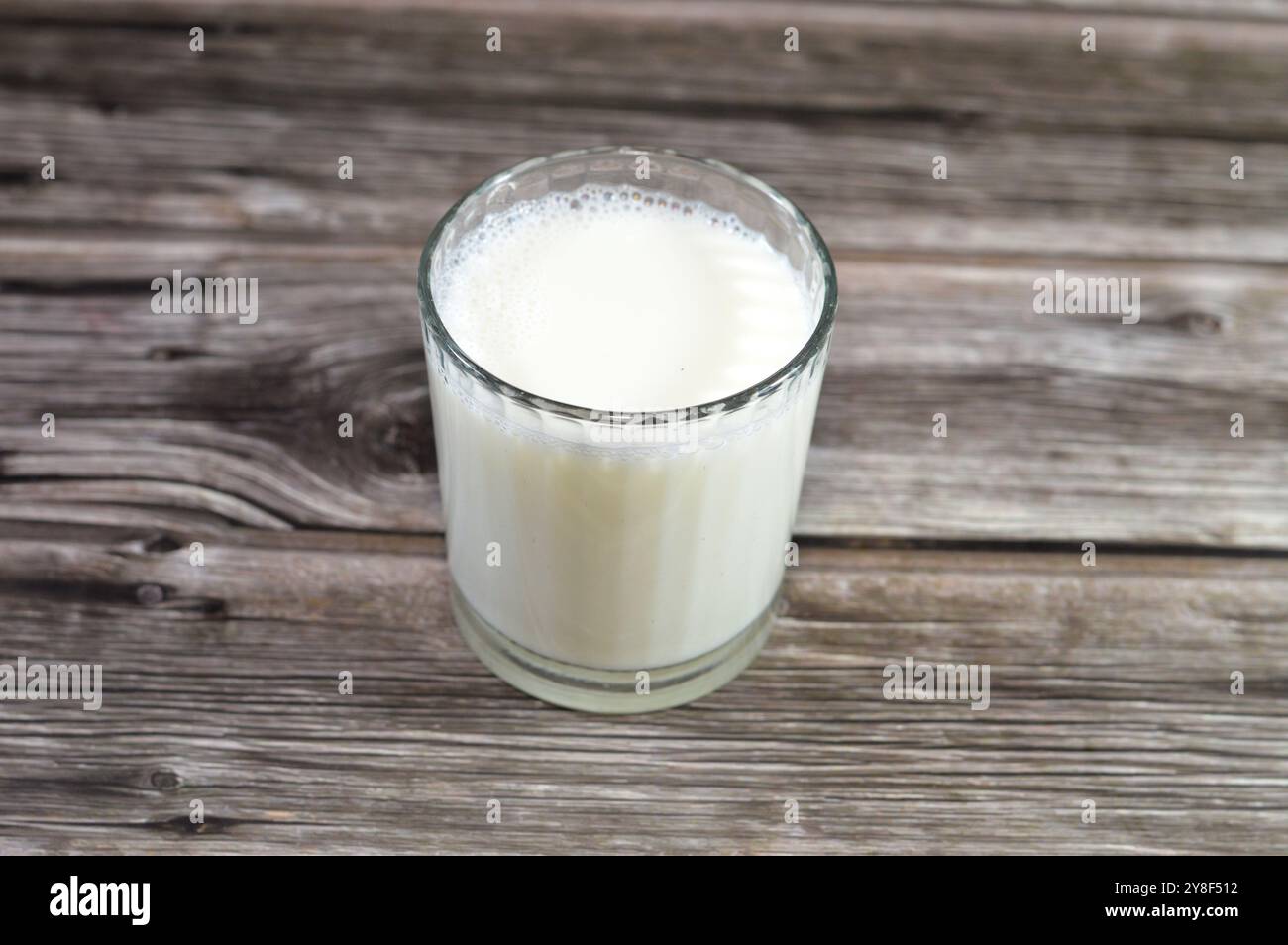 Glass of powdered dry milk, a manufactured dairy product made by ...