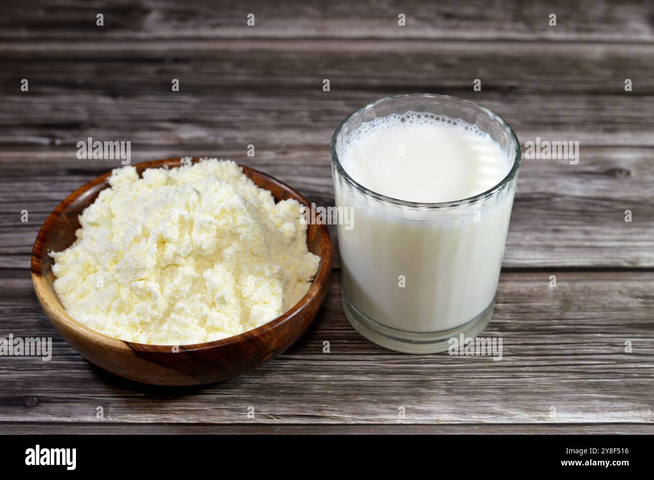 powdered dry milk and glass of milk, a manufactured dairy product made ...