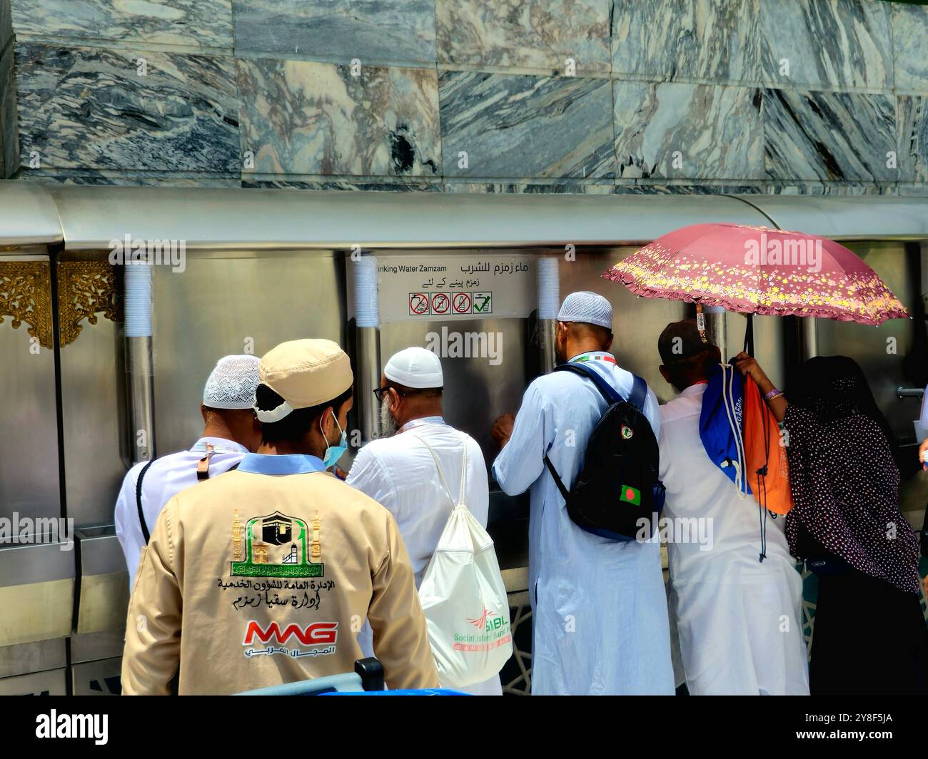 Mecca, Saudi Arabia, June 9 2024: pilgrims drinking from Zamzam well ...