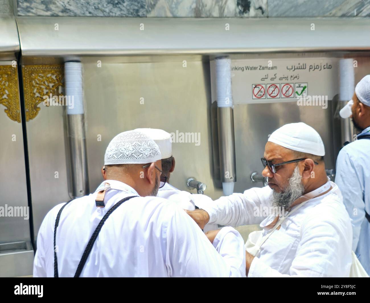 Mecca, Saudi Arabia, June 9 2024: pilgrims drinking from Zamzam well ...