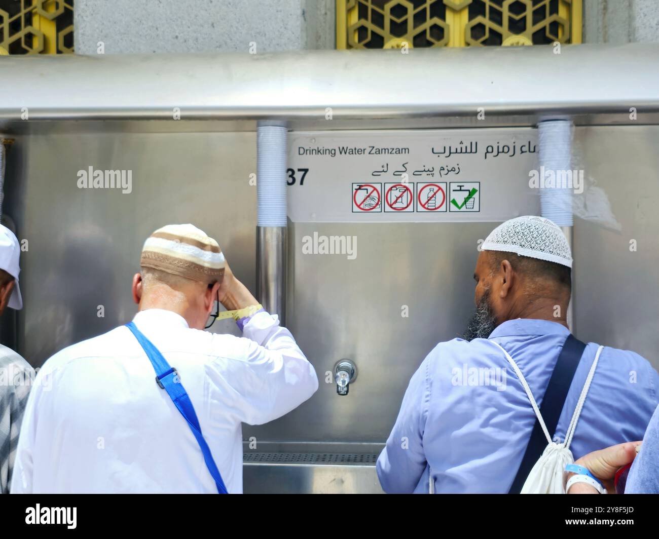 Mecca, Saudi Arabia, June 9 2024: pilgrims drinking from Zamzam well ...