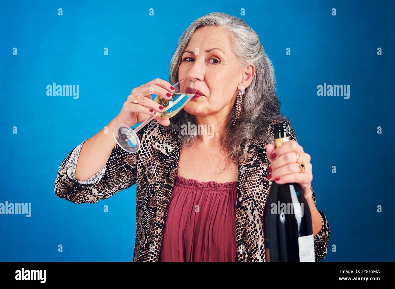 Drinking, portrait and woman with champagne in studio for celebration ...