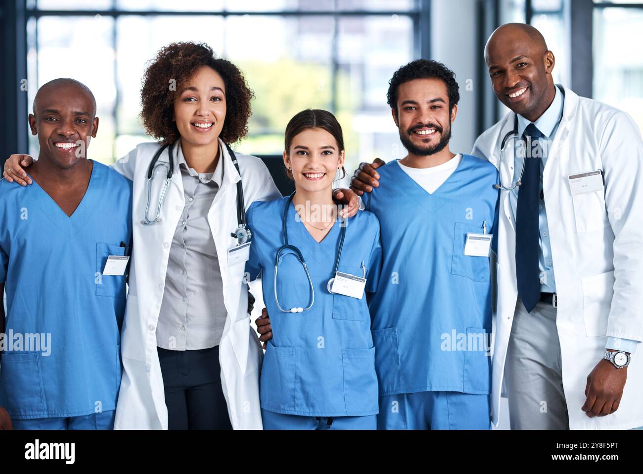 Portrait, group and doctors with embrace, hospital and collaboration ...