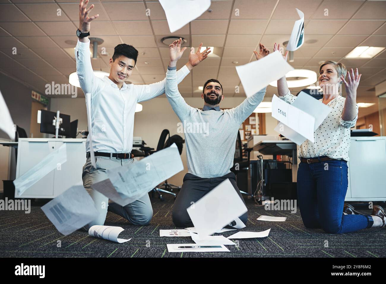 Throwing, paperwork and success of group, office and excited with ...