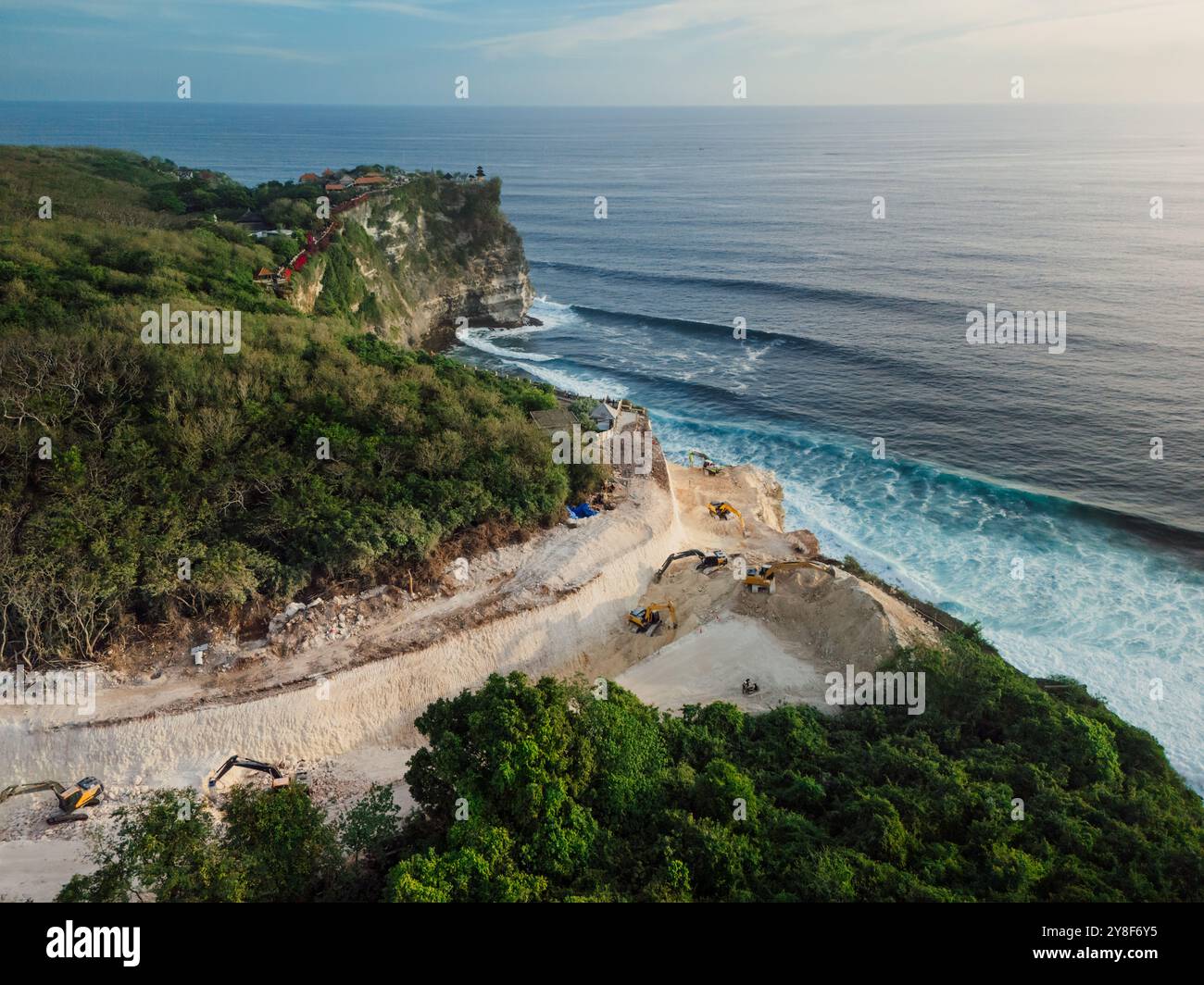 Development construction in Uluwatu, Bali. The work of escalators destruction of the rock Stock ...