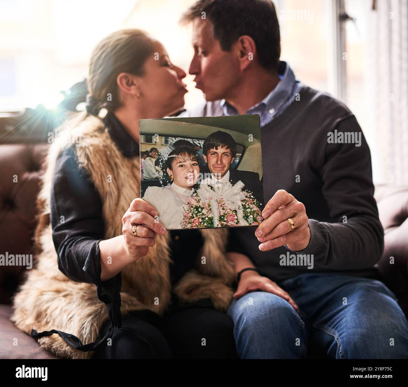 Photograph, sofa and couple kiss in home for nostalgia, remembering and ...