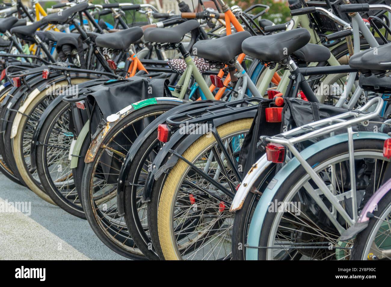 Netherlands. Several different bicycles in a row at a bicycle parking ...
