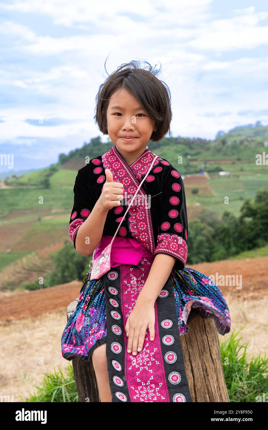 Young Hmong girl wearing traditional dress poses for the camera at the ...
