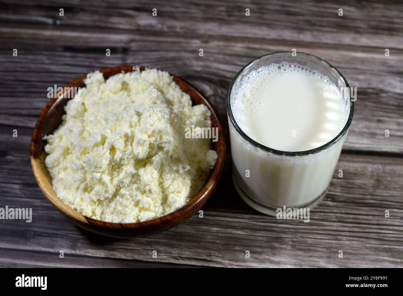 powdered dry milk and glass of milk, a manufactured dairy product made ...