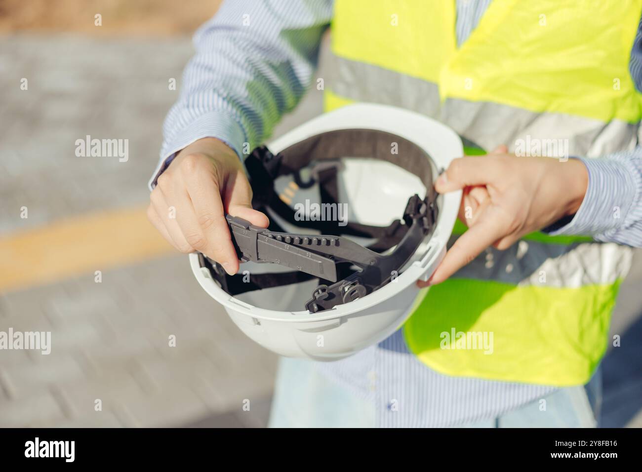 Engineer adjusts the size of the helmet before entering construction ...