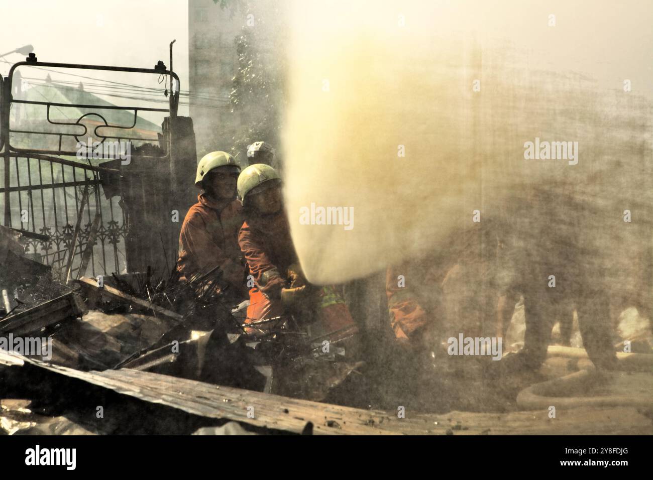 Members of Jakarta firefighting squad performing the cooling phase ...