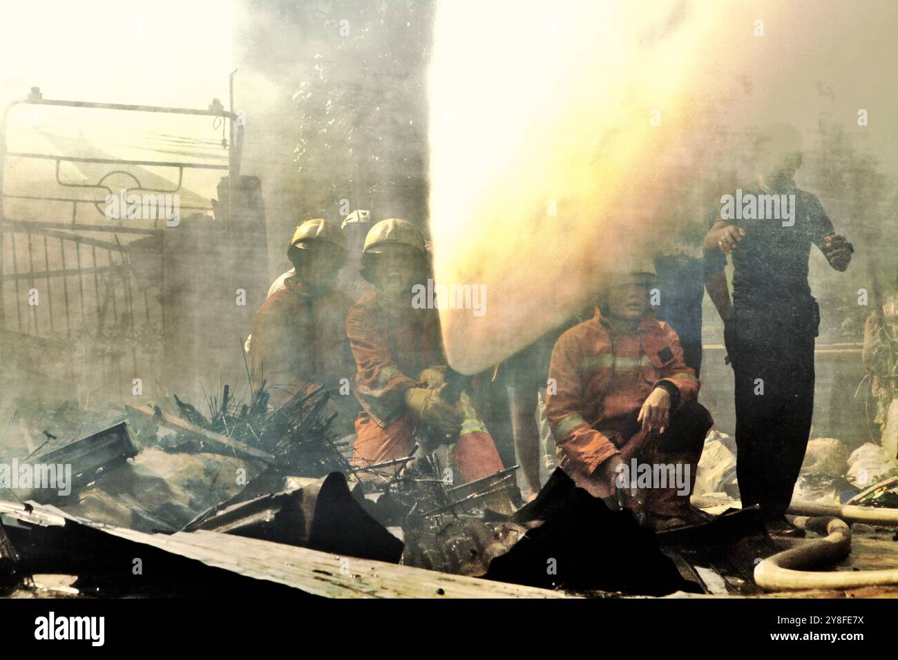 Members of Jakarta firefighting squad performing the cooling phase ...