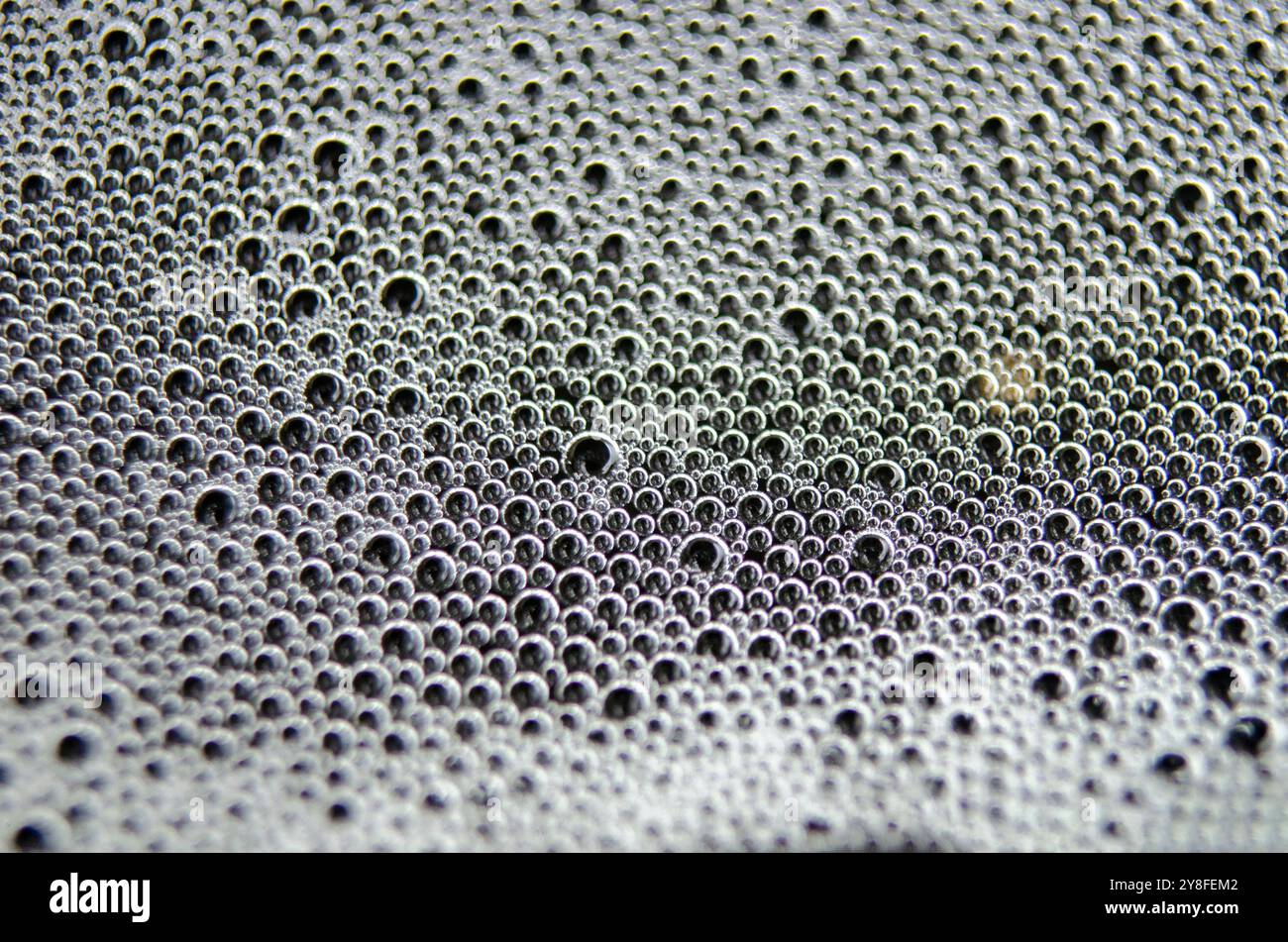 Soap bubbles forming patterns on a textured surface. Suitable for ...