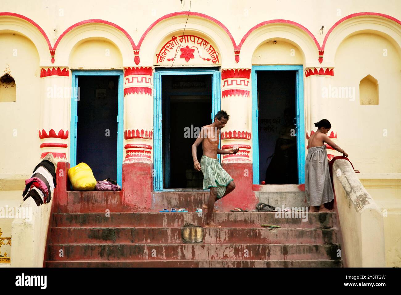 Pilgrims at the doors leading to a hot spring, which is believed to ...
