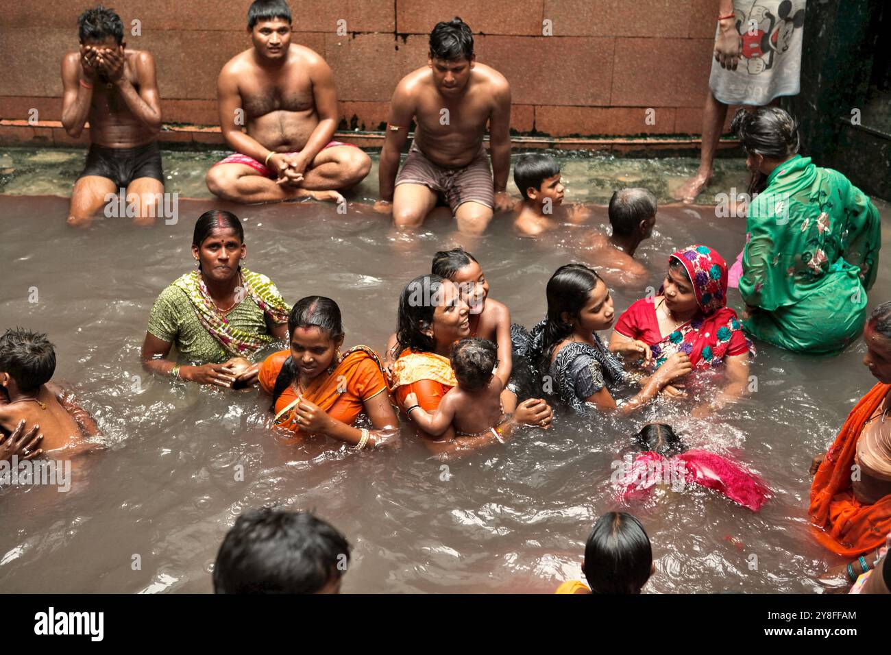 People taking a bath at a hot spring, which is believed to have ...