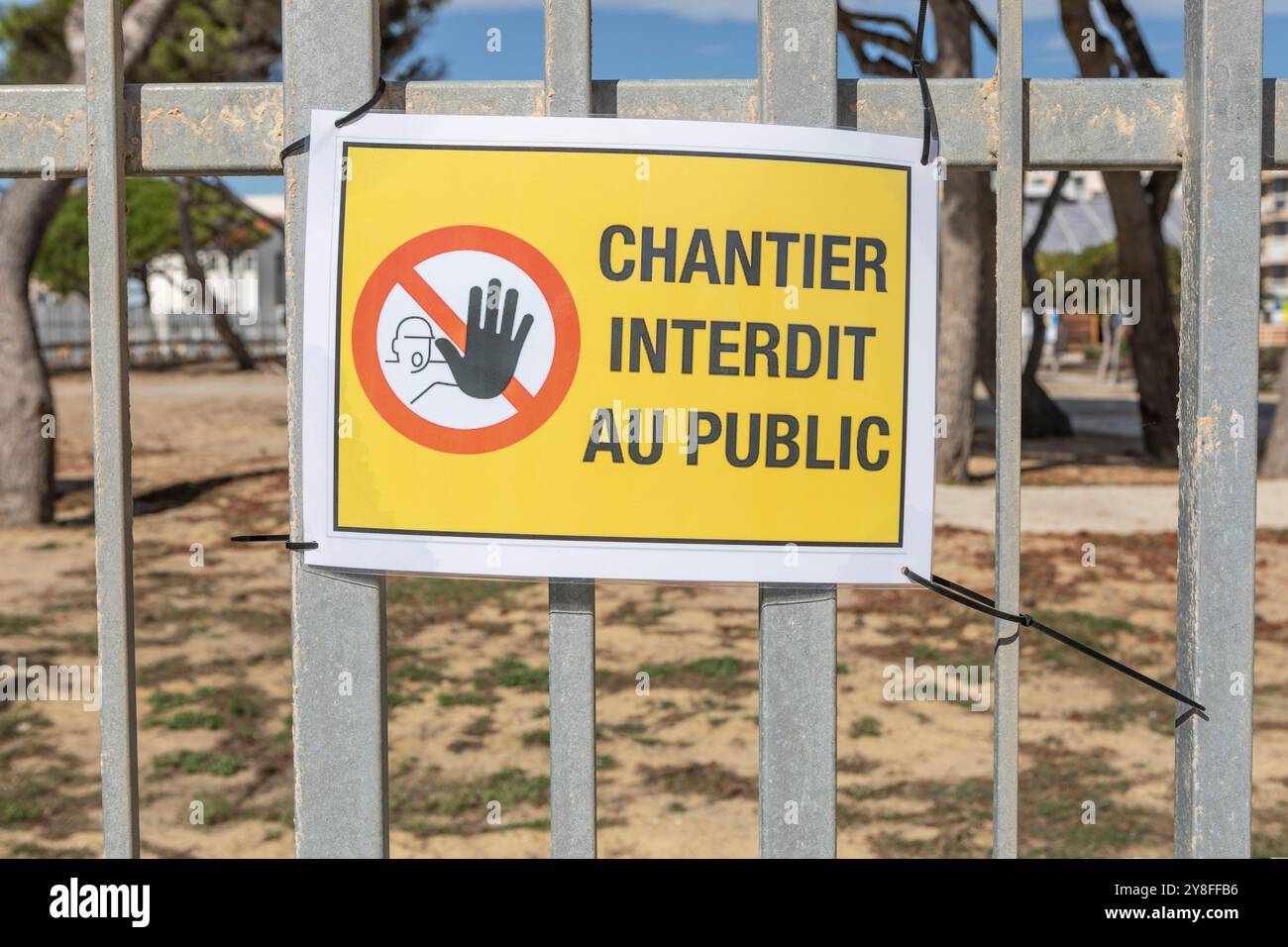 A keep out warning sign on a metal fence written in French Stock Photo ...