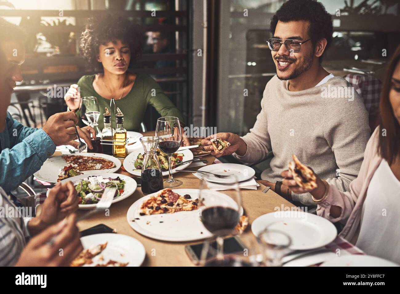 Happy people, eating and talking at restaurant for bonding, social ...