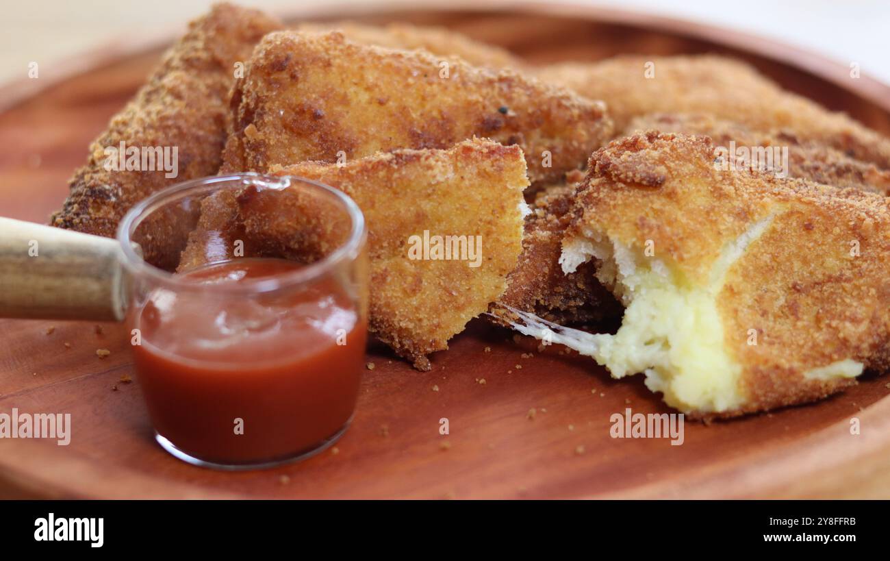 Crispy Breaded Cheese Snacks with Spicy Tomato Dip on Wooden Plate ...