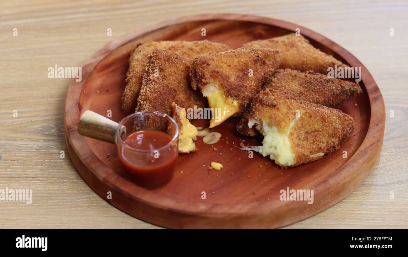 Crispy Breaded Cheese Snacks with Spicy Tomato Dip on Wooden Plate ...