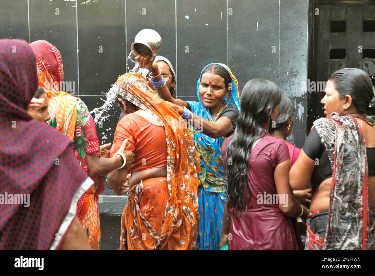 People taking a bath at a hot spring, which is believed to have ...
