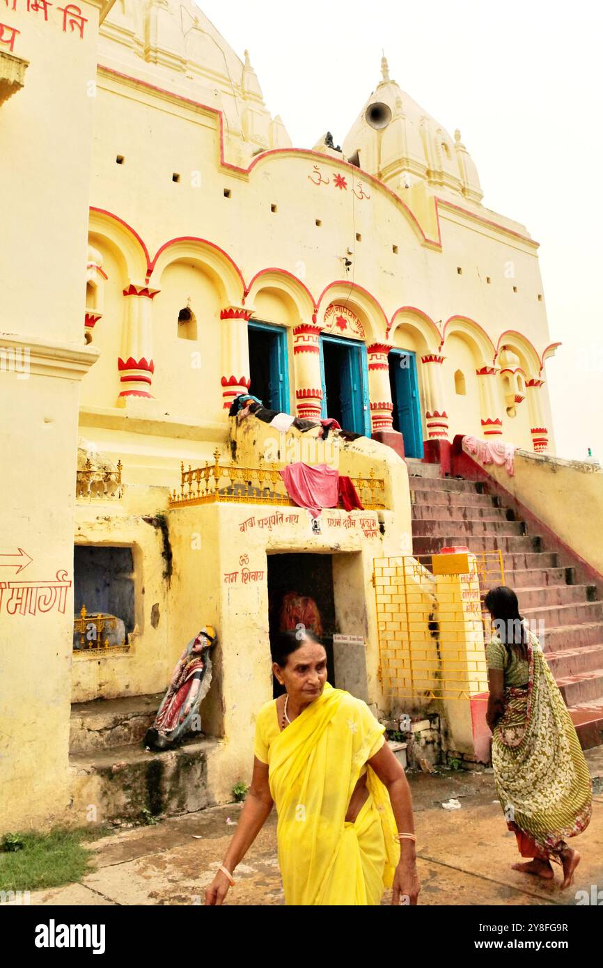 Women in front of a building where pilgrims can take a bath at a hot ...