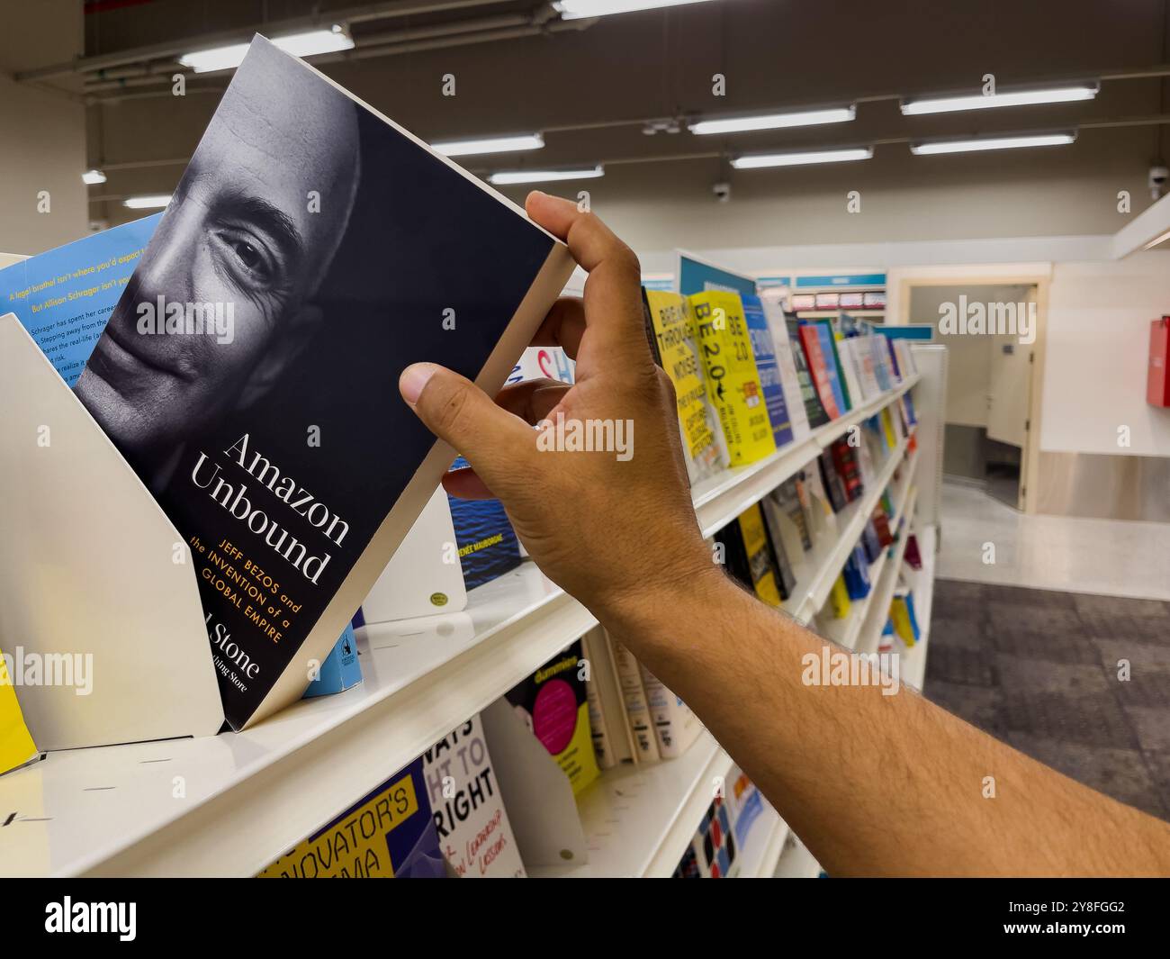 Man selecting a book from library bookshelf in Doha, Qatar Oct 05, 2024 ...