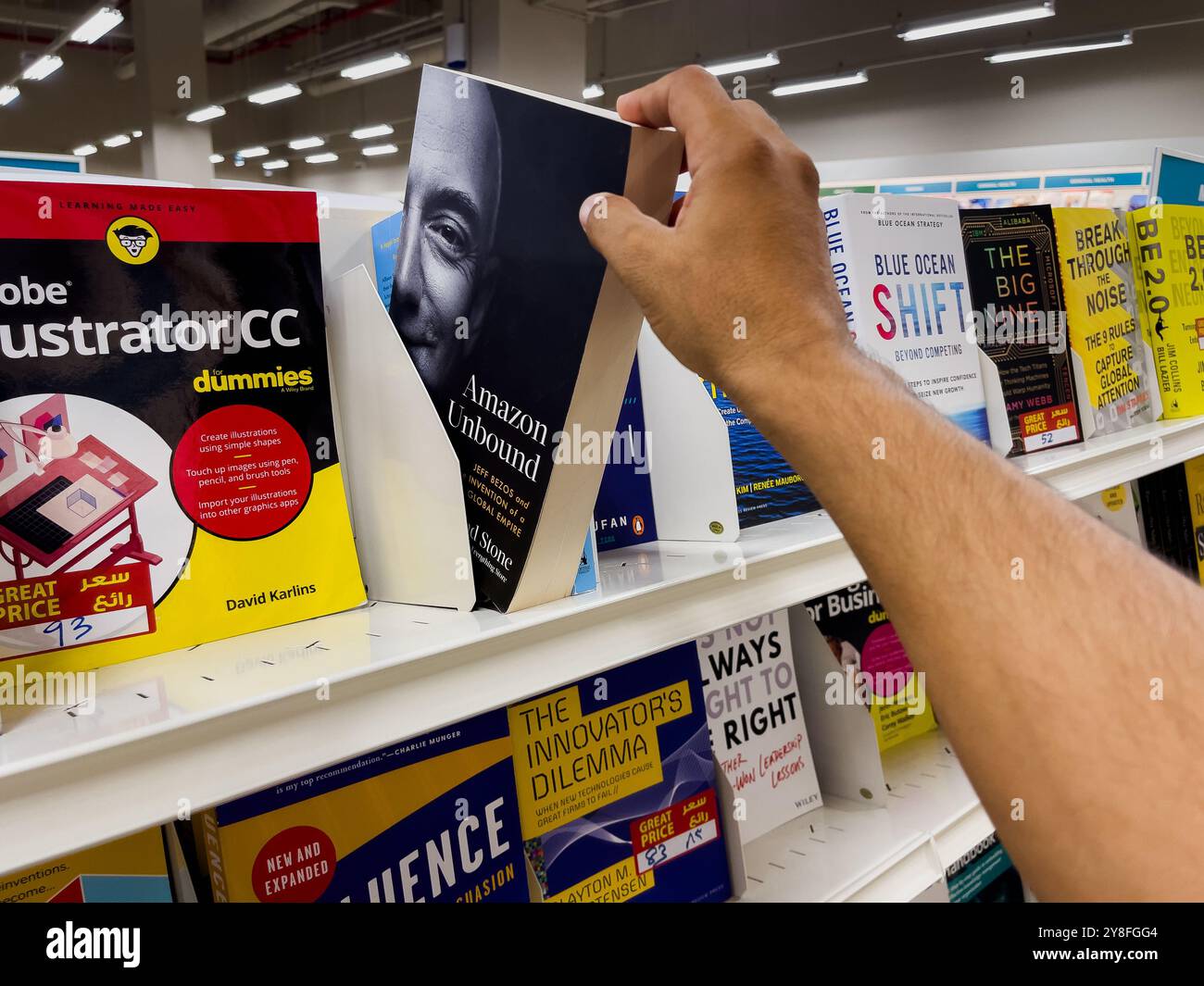 Man selecting a book from library bookshelf in Doha, Qatar Oct 05, 2024 ...
