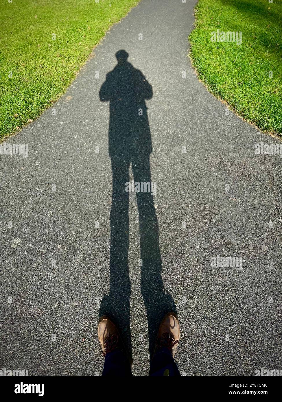 Shadow person on footpath Stock Photo - Alamy