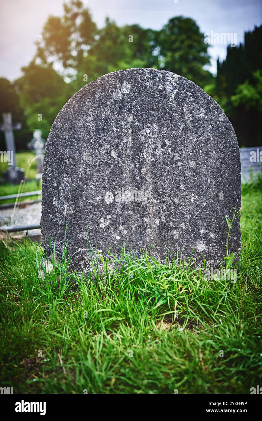 Tombstone, grass and cemetery for peace, funeral and memory or empty ...
