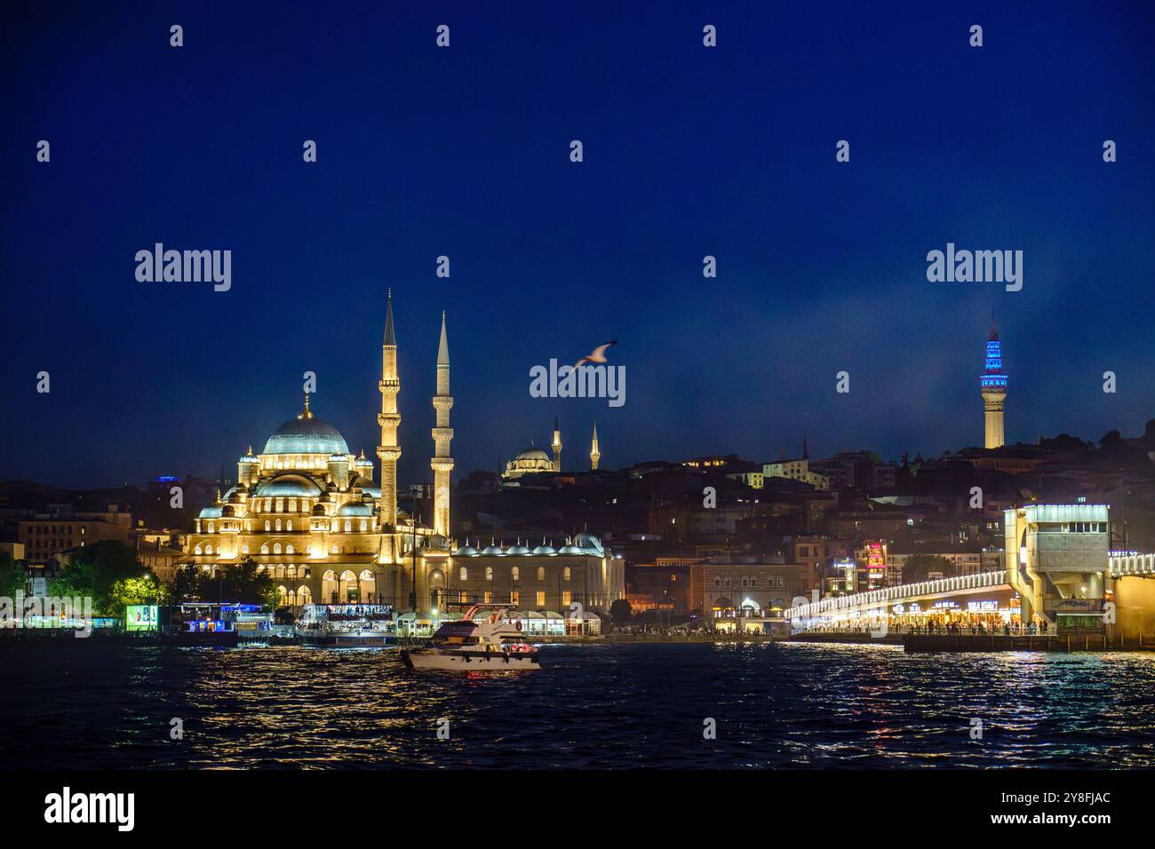 Turkiye. Istanbul. A night view of the Yeni Cami Mosque and the Galata ...