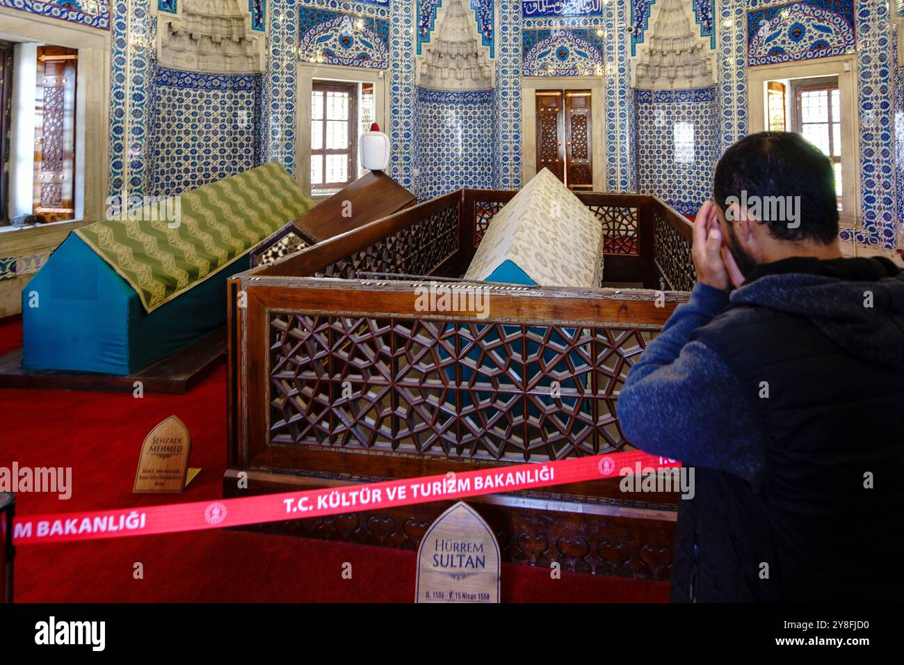 Turkiye. Istanbul. Suleymaniye Mosque. A man pray front of the tomb of ...