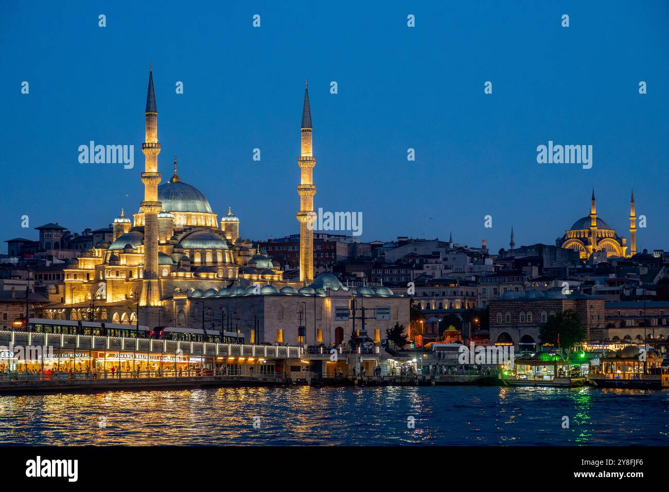 Turkiye. Istanbul. The Yeni Cami Mosque illuminated with the Galata ...