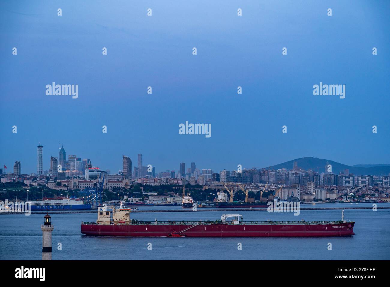 Istanbul. Türkiye. A large cargo ship sails through the Bosphorus ...