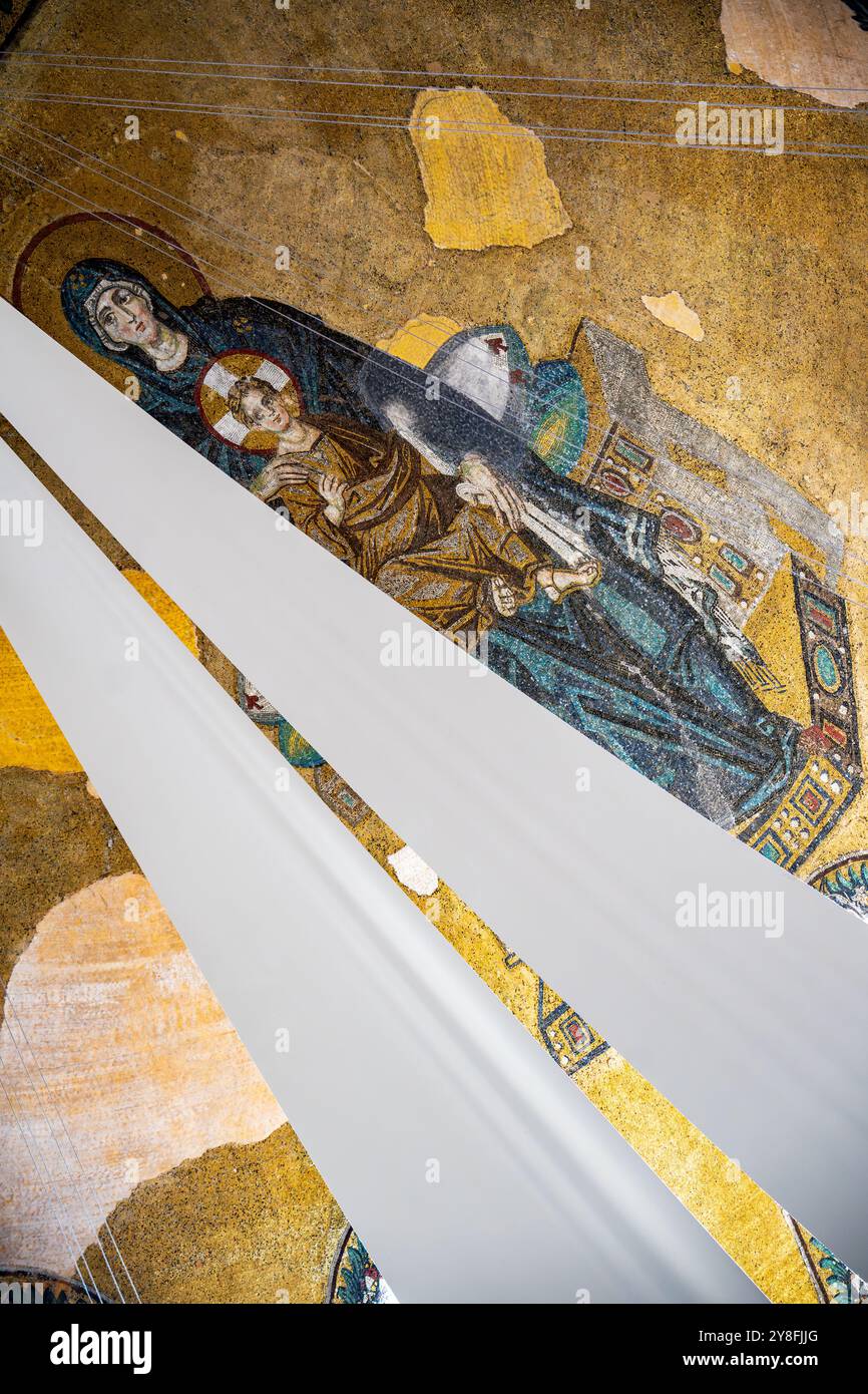 Türkiye. Istanbul. Hagia Sophia mosque. Mosaic of the Virgin and Child partially veiled. Mary is ...