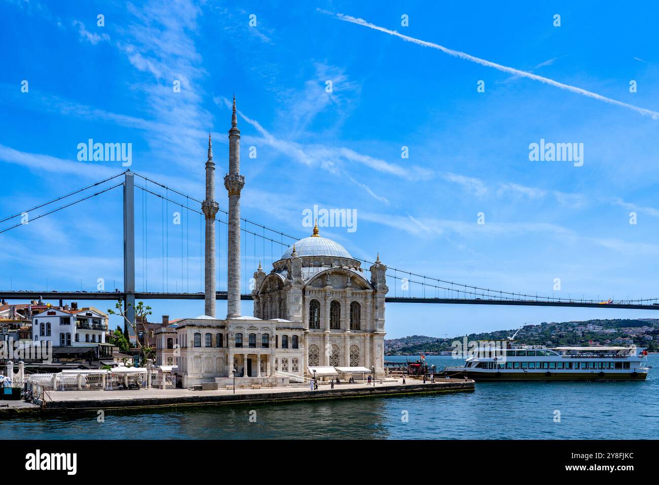 Turkiye. Istanbul. A cruise ship docks in front of the Ortakoy Mosque ...