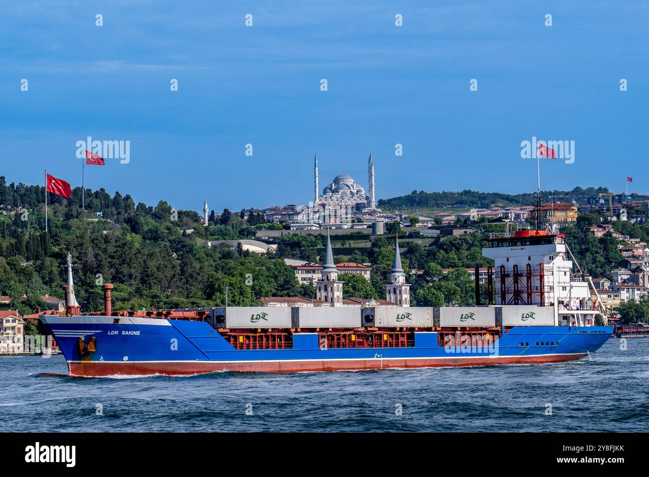 Turkiye. Istanbul. A large cargo ship sails through the Bosphorus ...
