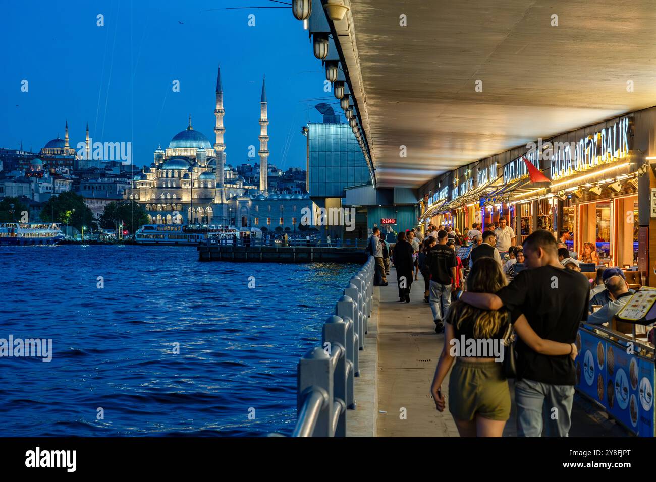 Turkiye. Istanbul. Night scene on the Galata Bridge, with bustling ...