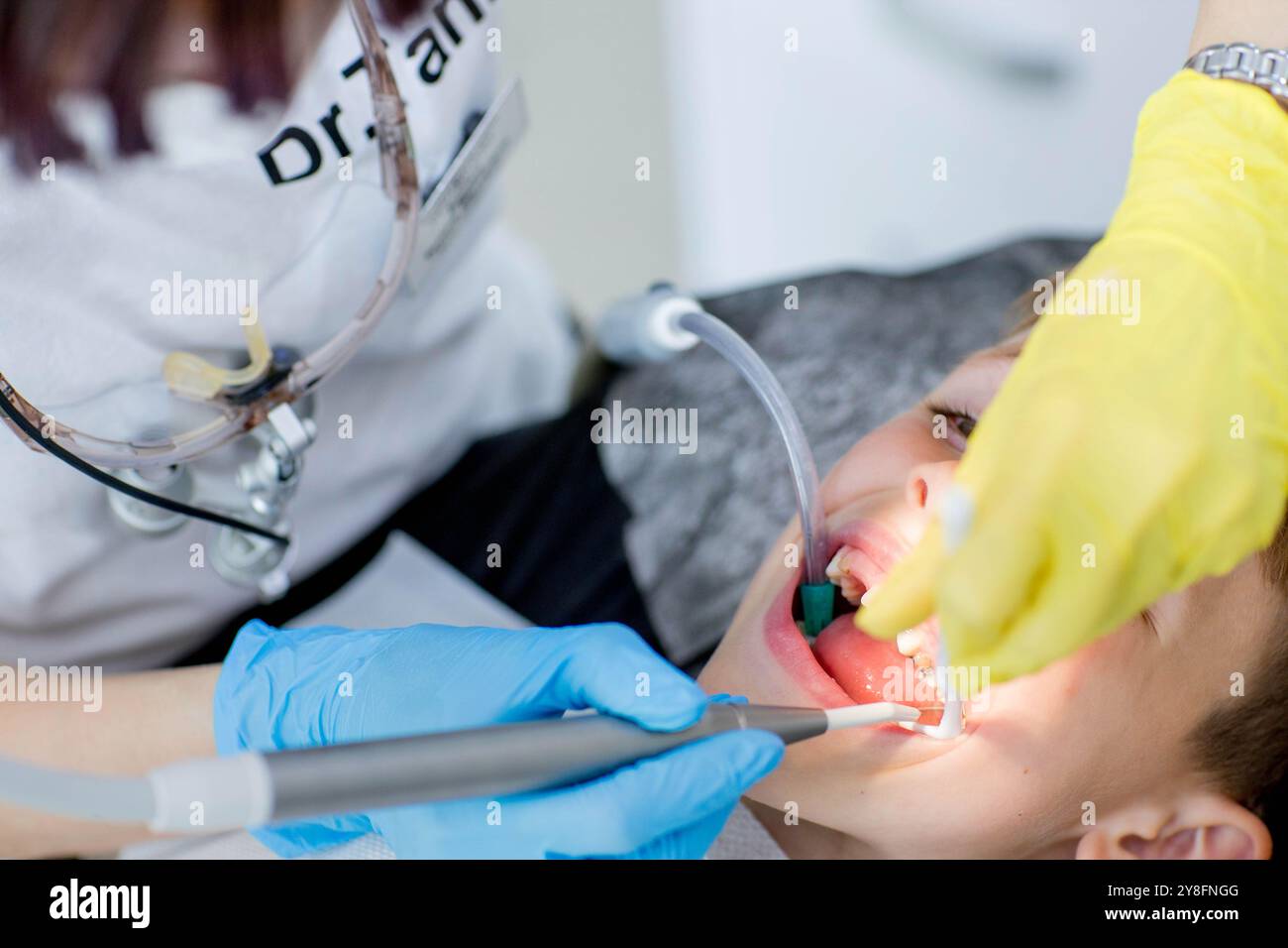 Children's dentistry. First examination at the dentist. A cute handsome ...