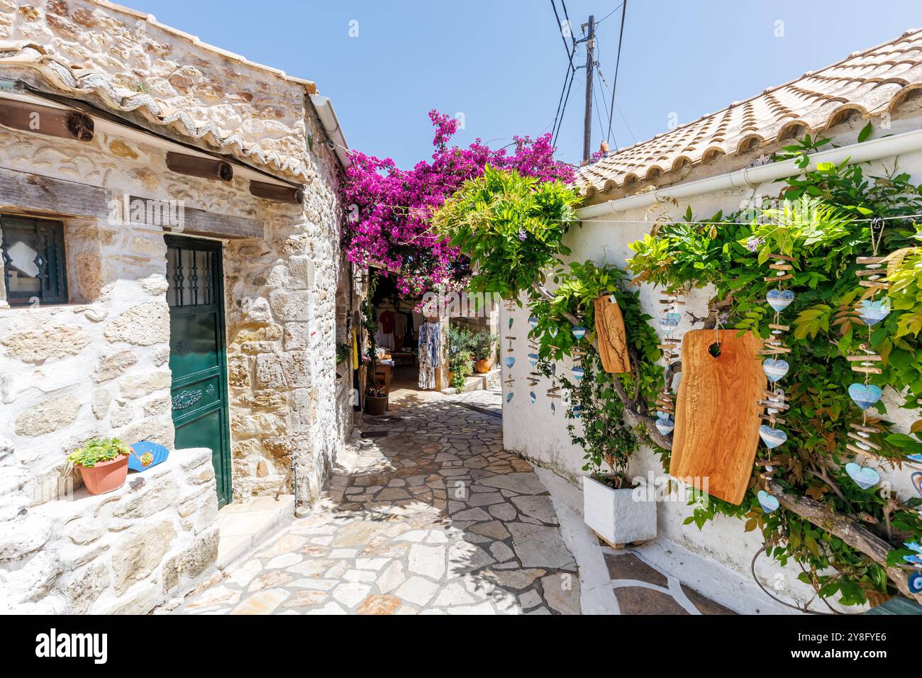Alley decorated with flowers in the picturesque village of Afionas ...
