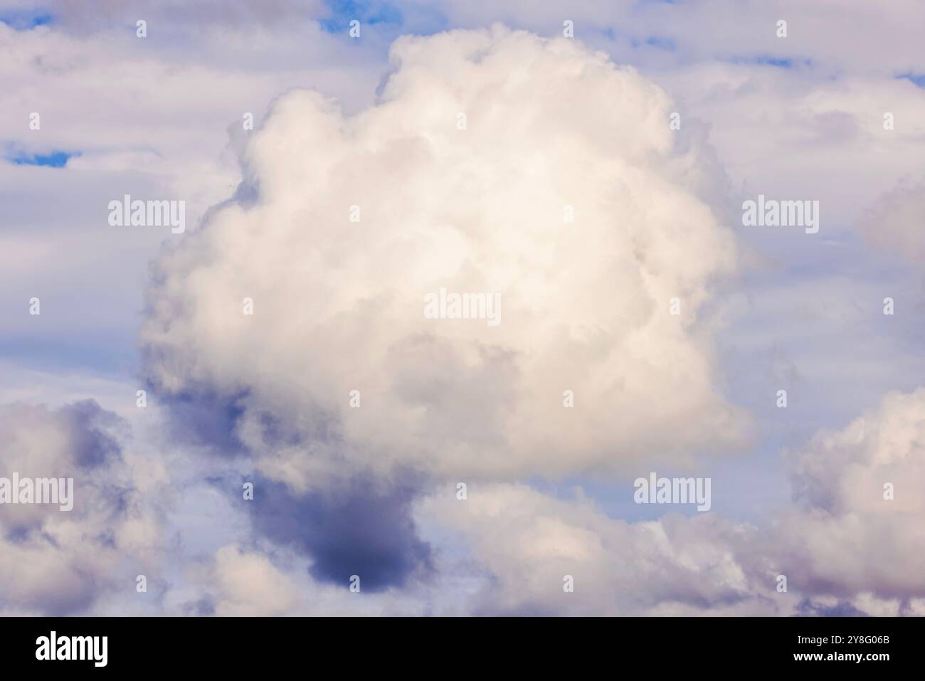 Fluffy white cloud in the sky with soft, diffused sunlight illuminating ...