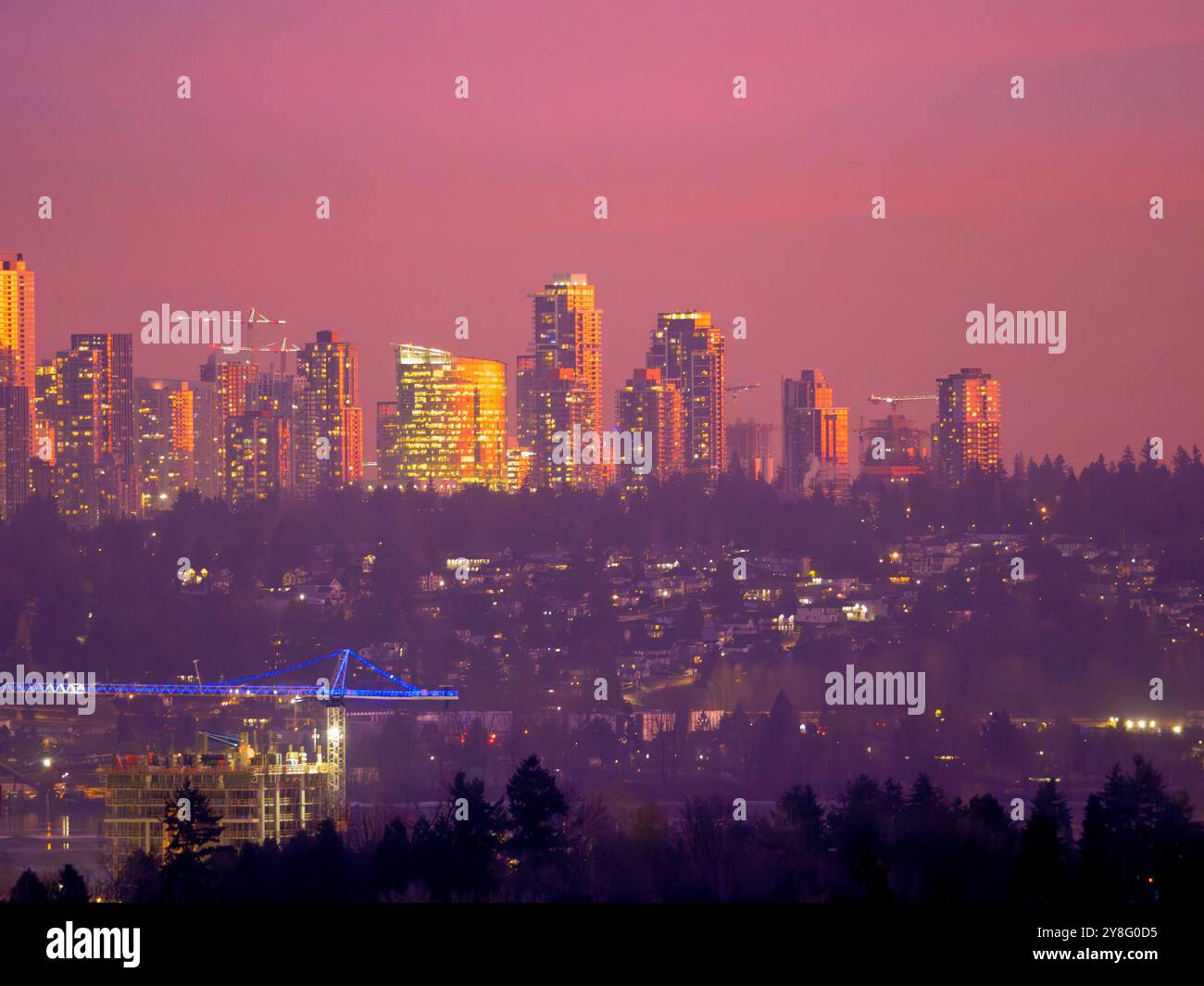 Unusual night city silouette highlighted with sunset rays in Surrey, BC ...