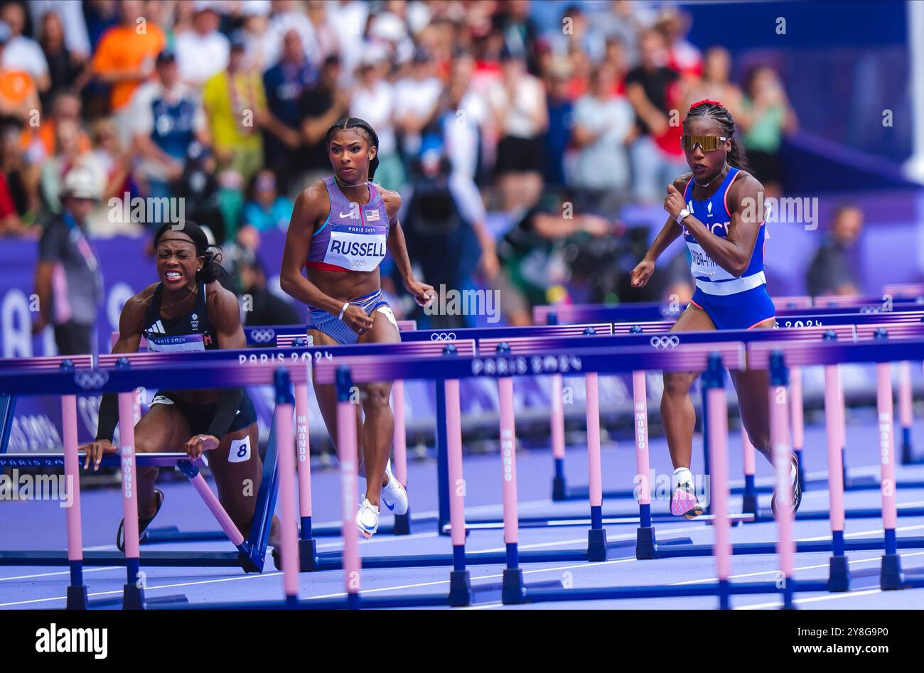 Masai Russell participating in the 100 meters hurdles at the Paris 2024 ...
