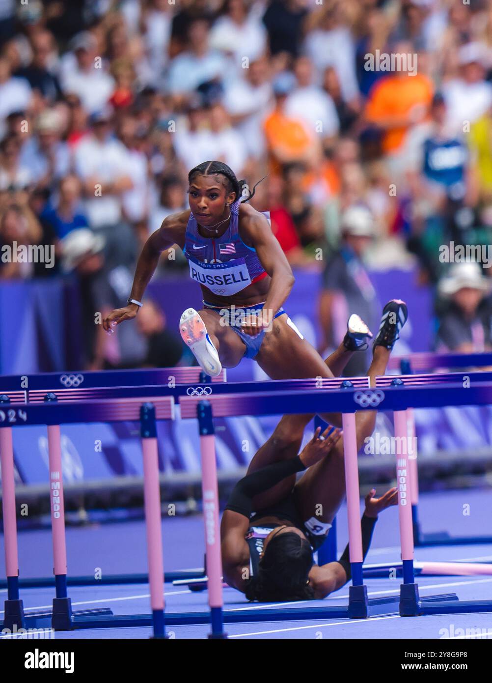 Masai Russell participating in the 100 meters hurdles at the Paris 2024 ...