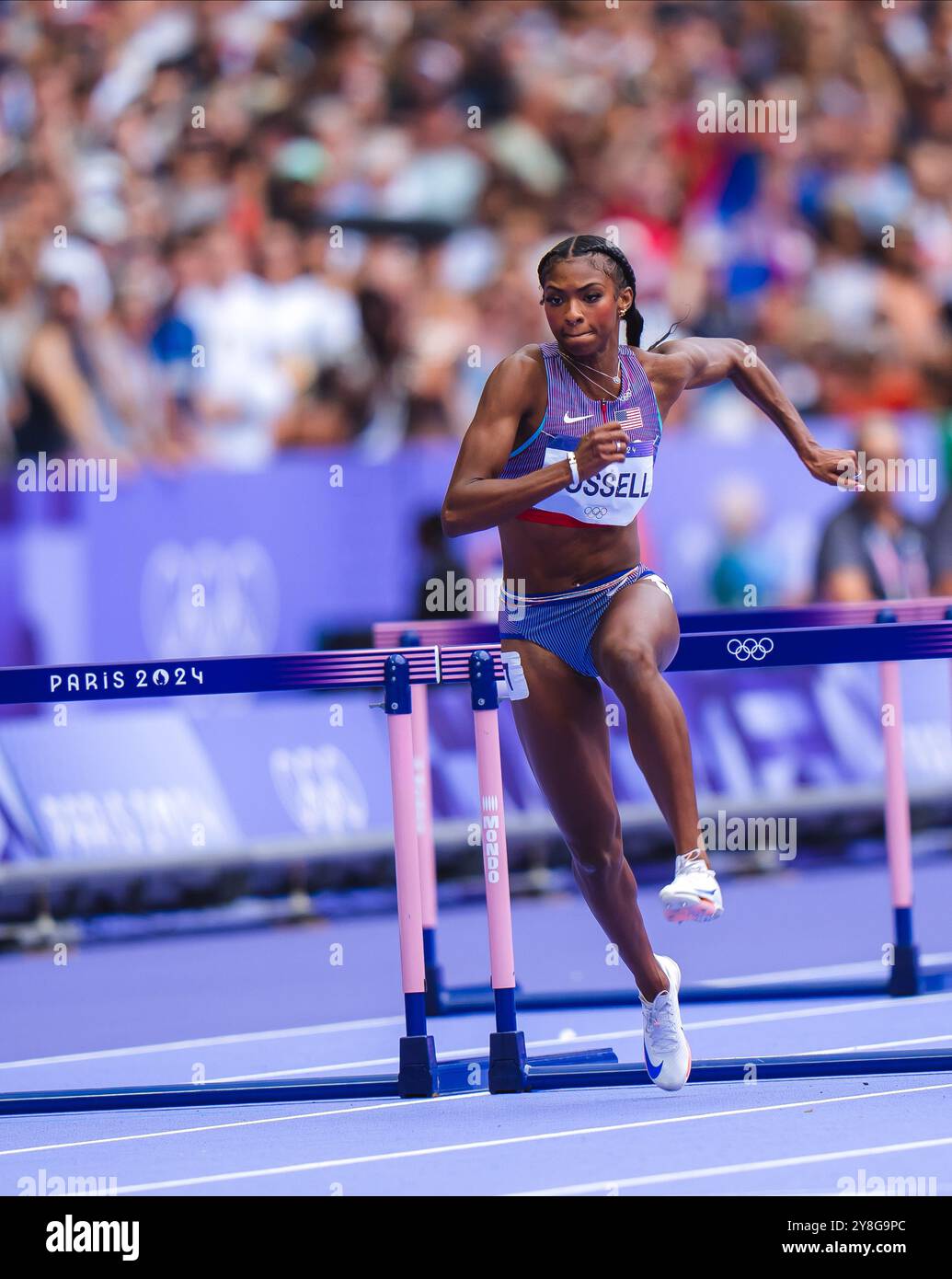 Masai Russell participating in the 100 meters hurdles at the Paris 2024 ...