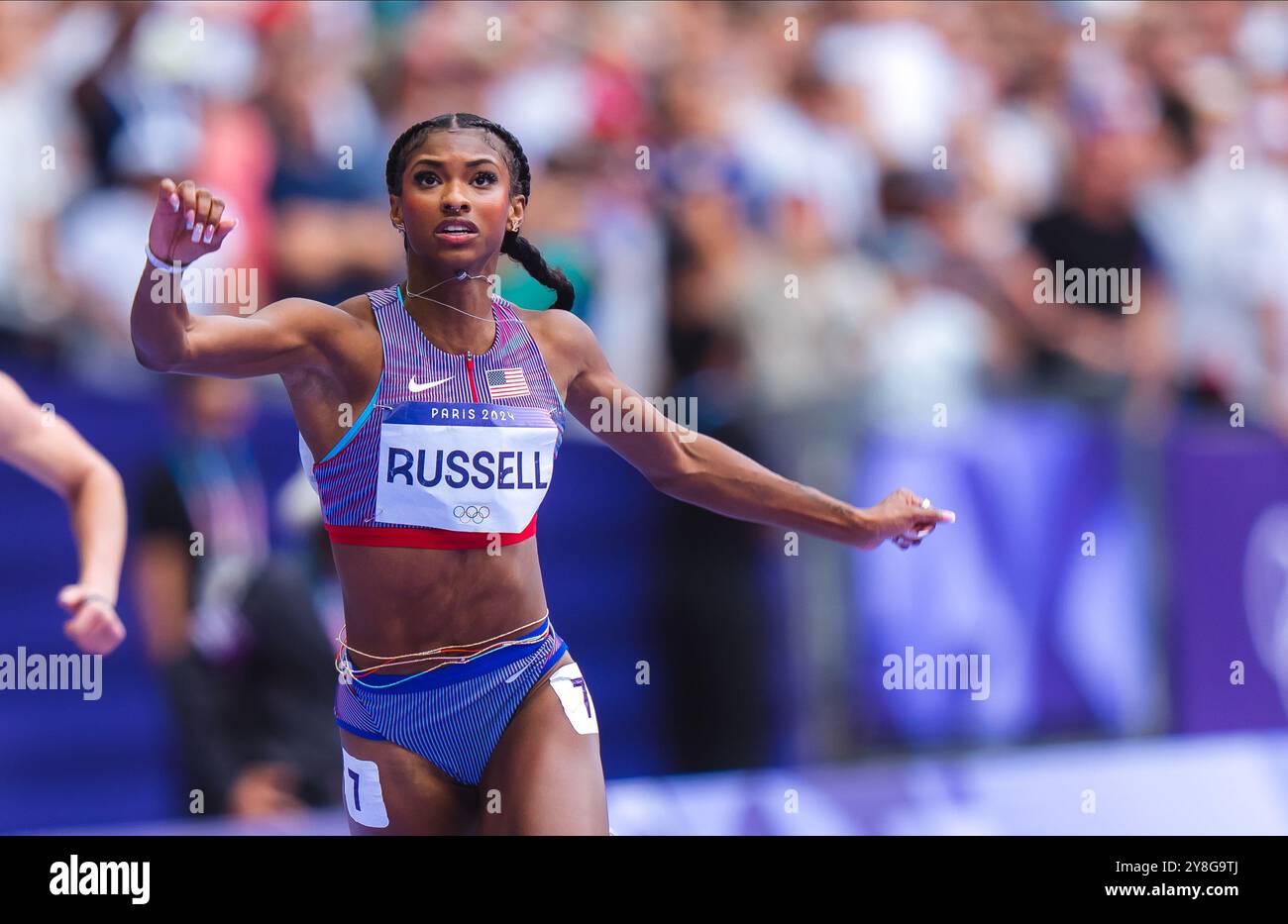 Masai Russell participating in the 100 meters hurdles at the Paris 2024 ...