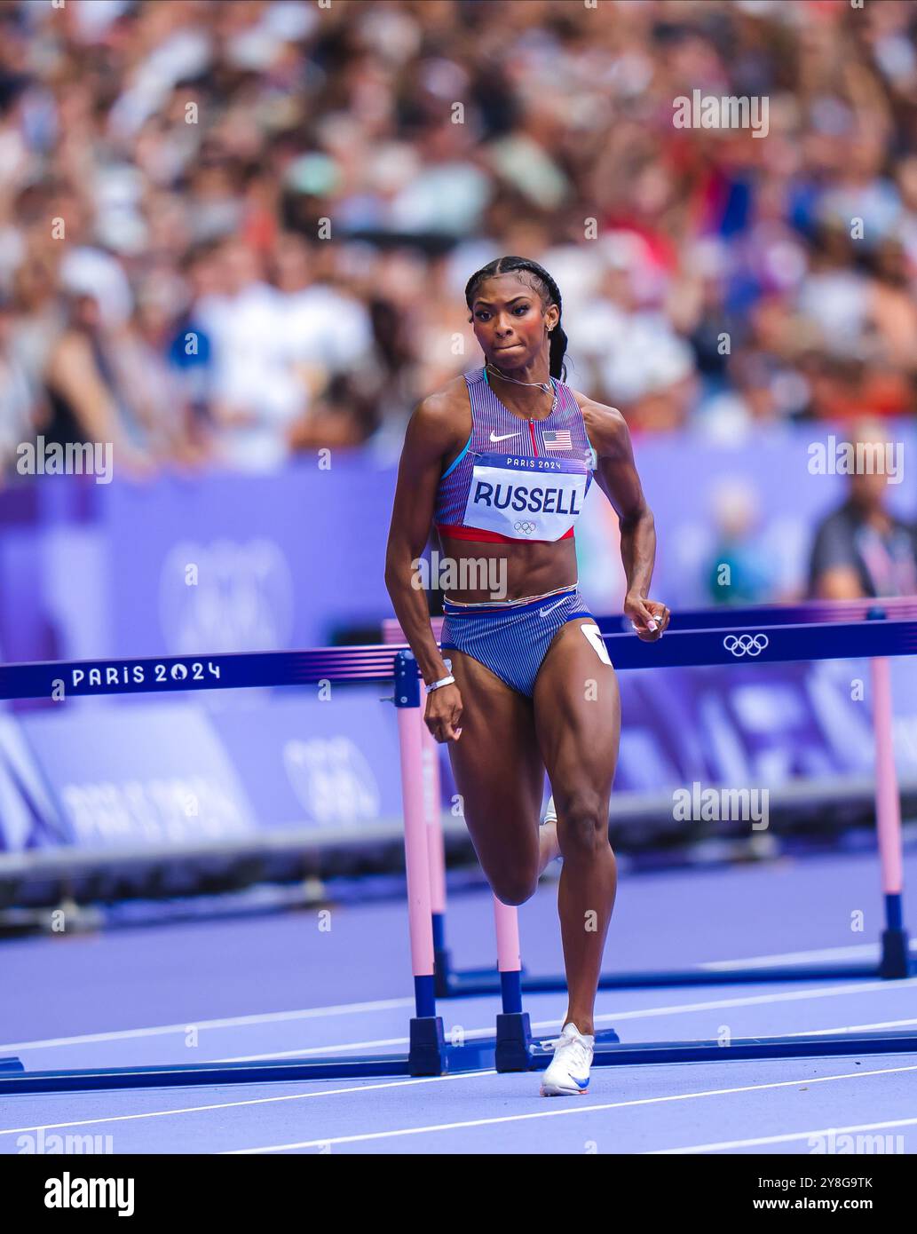 Masai Russell participating in the 100 meters hurdles at the Paris 2024 ...