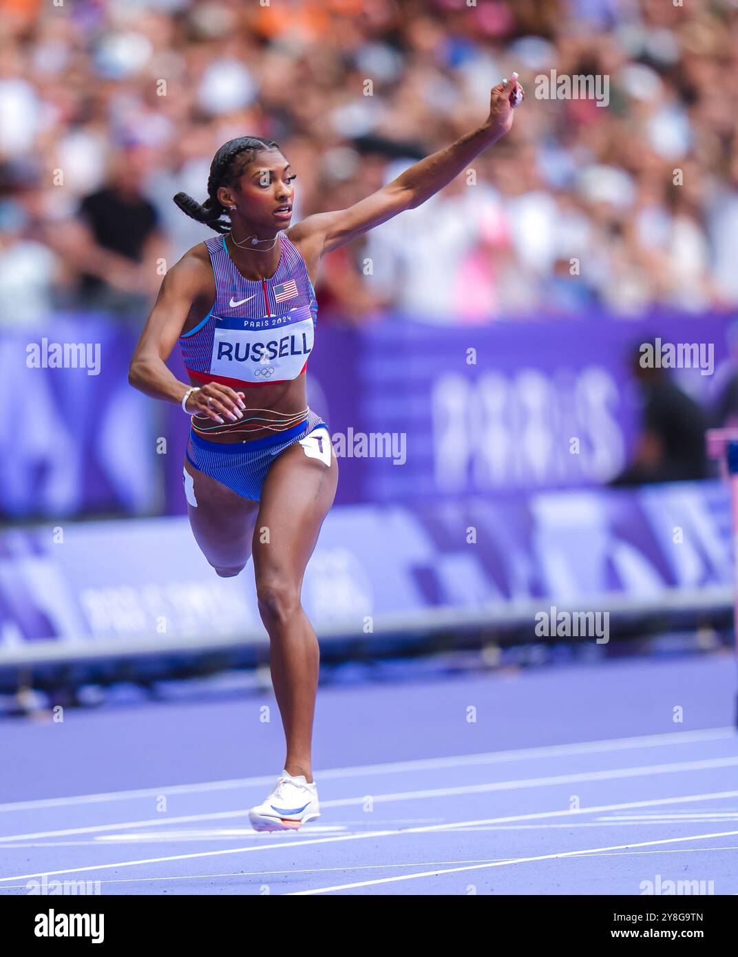 Masai Russell participating in the 100 meters hurdles at the Paris 2024 ...